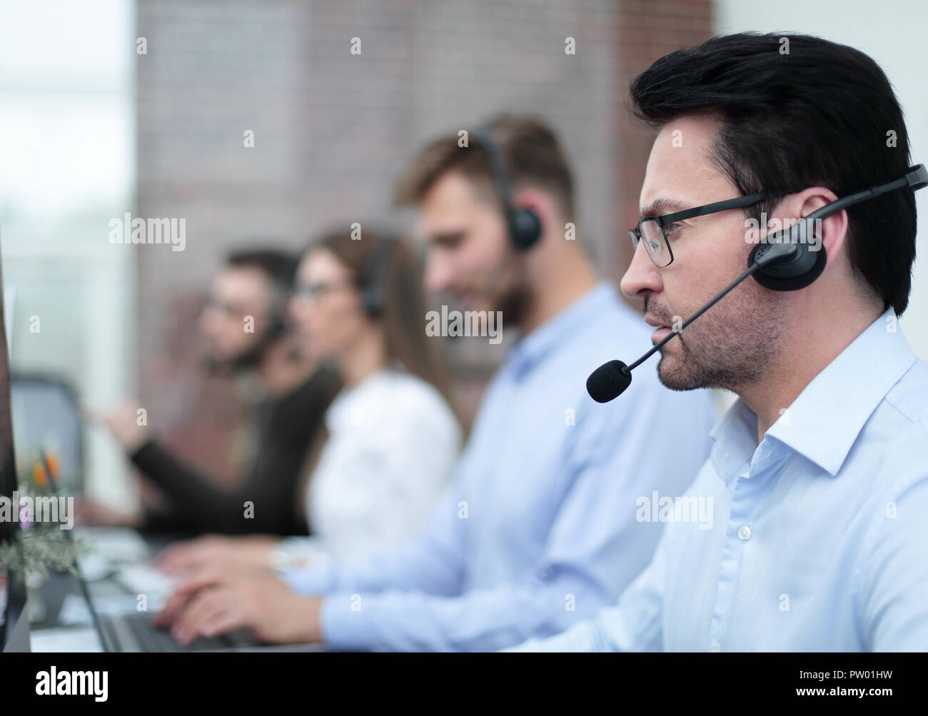 technical support specialist on the background of colleagues Stock ...