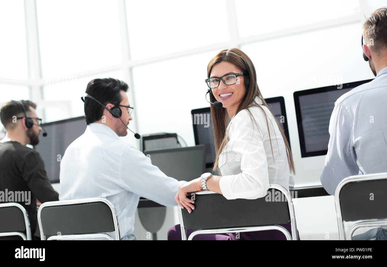 rear view.woman Telecom operator in the workplace in the call center ...