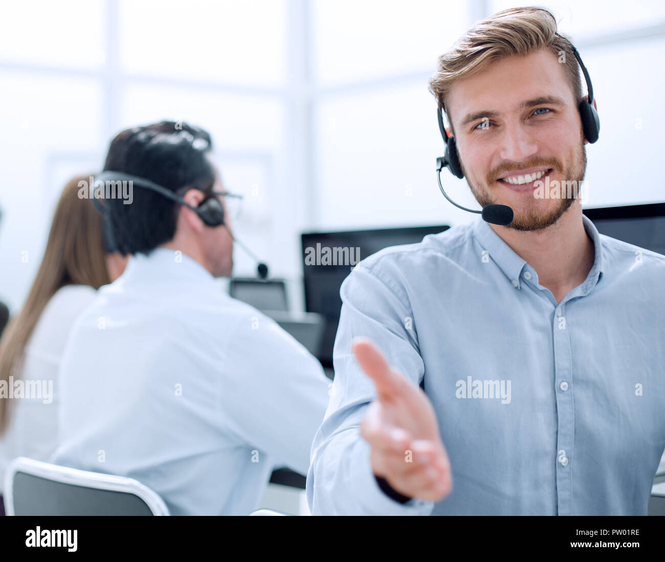 call operator stretching out his hand for a handshake Stock Photo - Alamy
