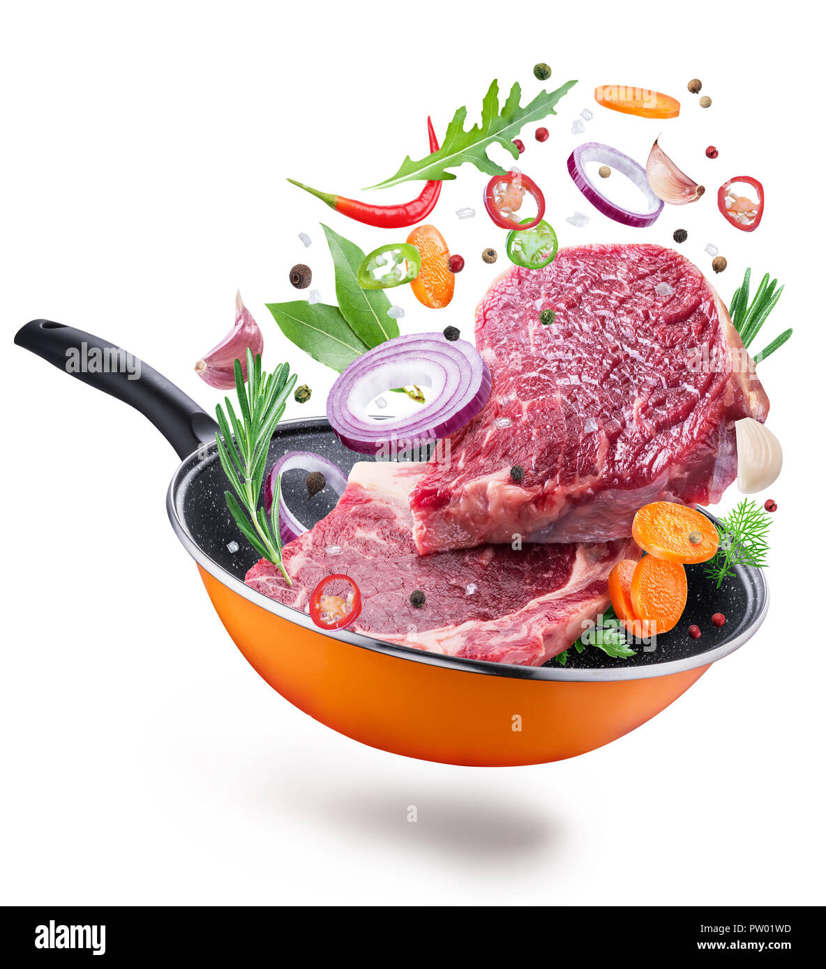 Flying meat steaks and spices over a frying pan. File contains clipping ...