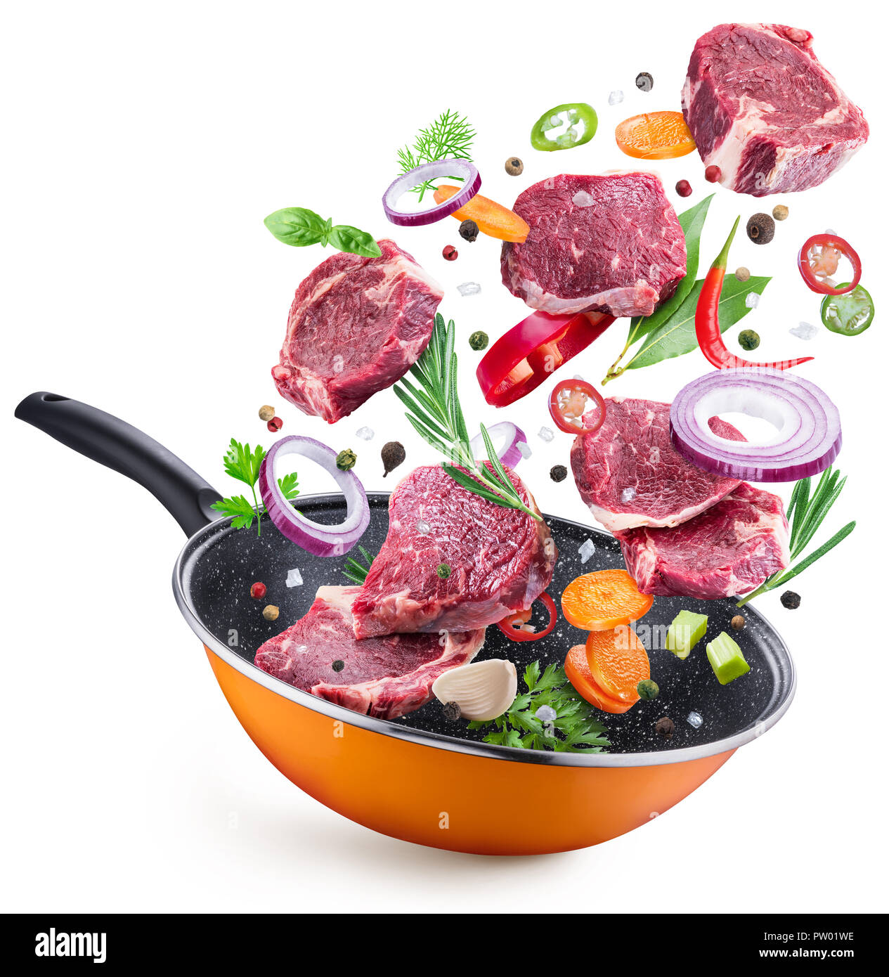 Flying meat steaks and spices over a frying pan. File contains clipping ...