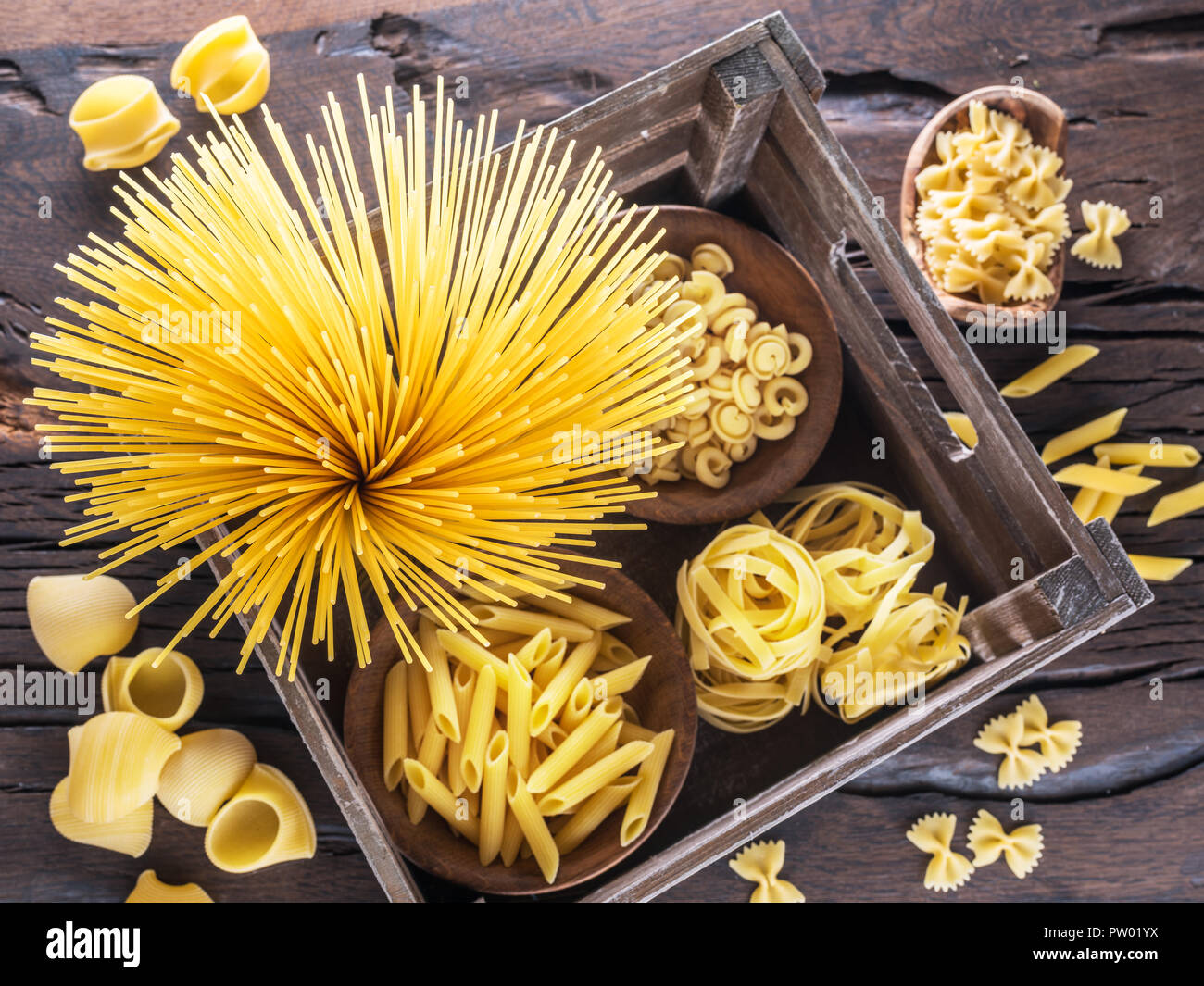 Different pasta types on the wooden table. Top view Stock Photo - Alamy