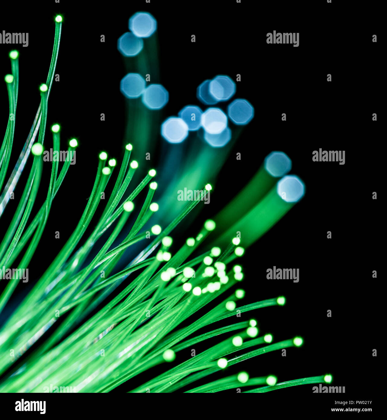 Bundle of optical fibers with green light. Black background Stock Photo ...