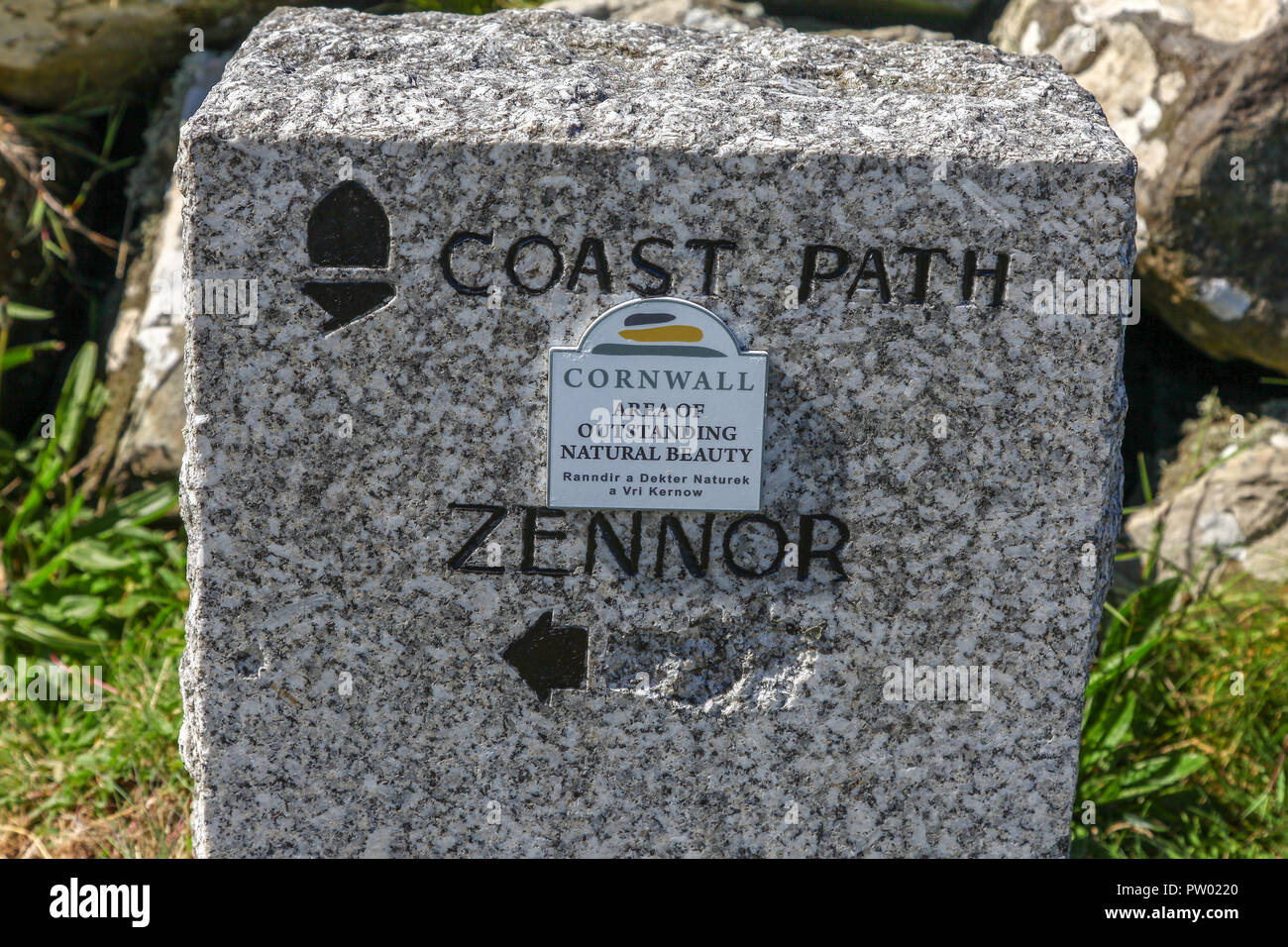 A granite sign post on the South West Coast path saying Cornwall Area ...