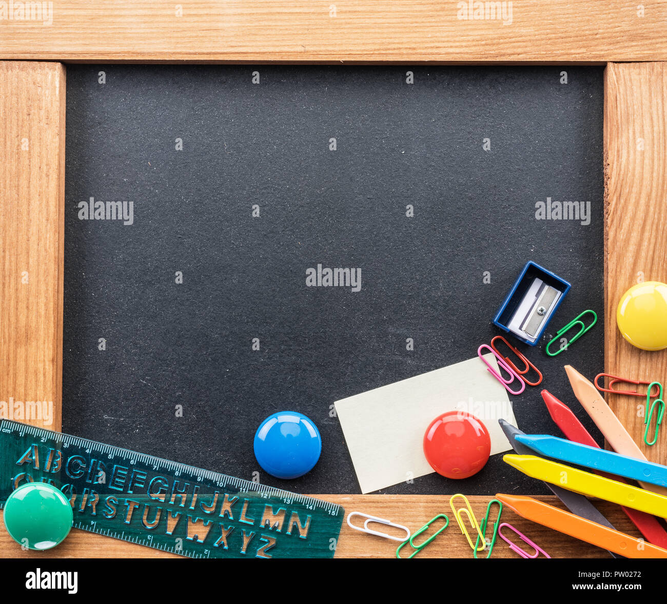 Blackboard and different school things. Close up Stock Photo - Alamy