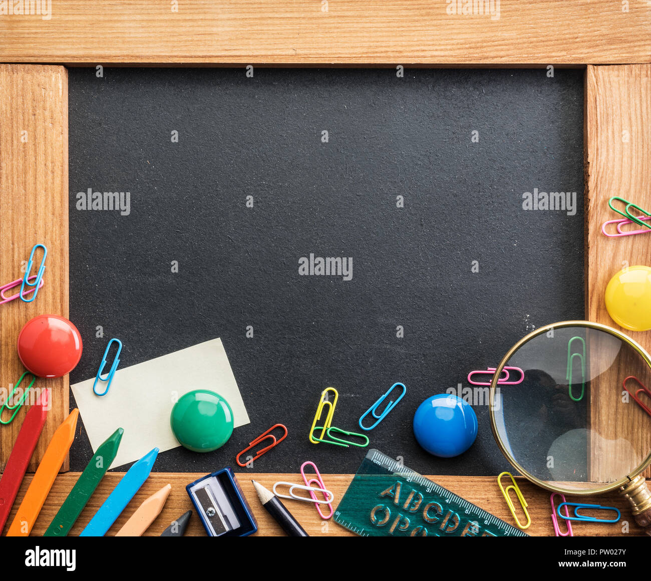 Blackboard and different school things. Close up Stock Photo - Alamy