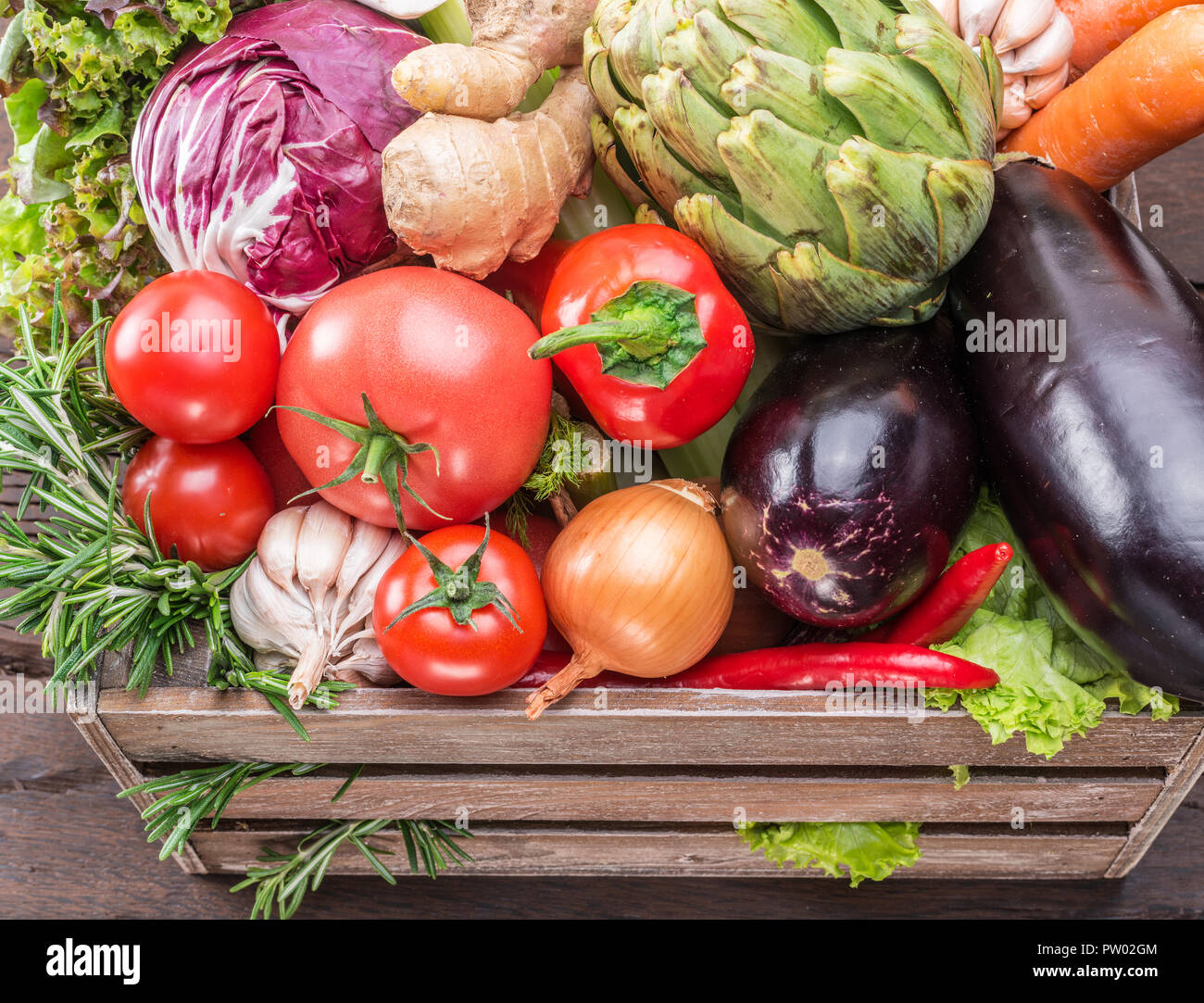 Fresh multi-colored vegetables in wooden crate. Top view Stock Photo ...