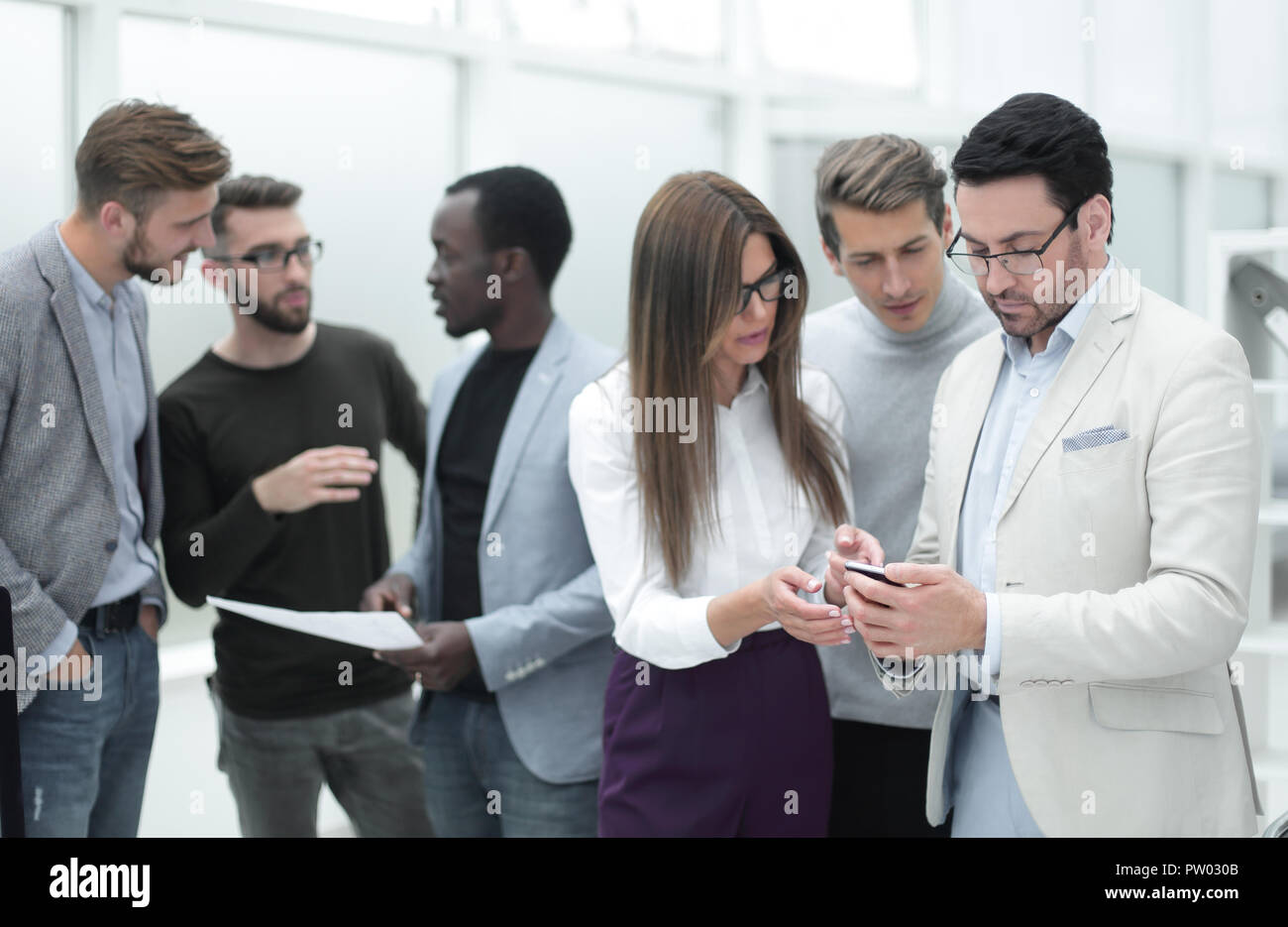 employees discuss working documents standing in the office Stock Photo ...