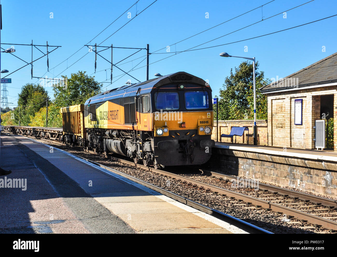 Class 66 diesel locomotive heads freight wagons through the station at ...