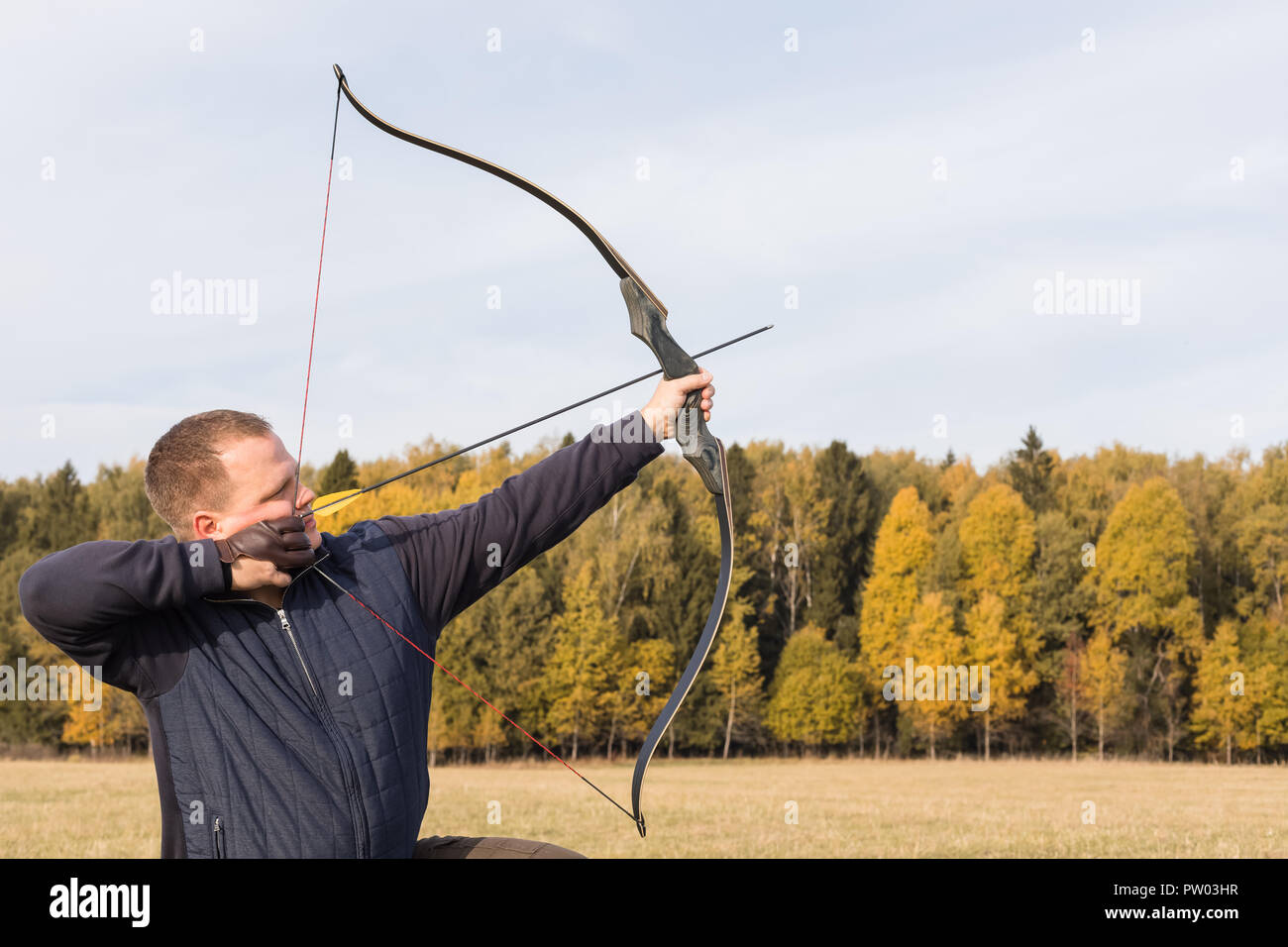 Athlete aiming at a target and shoots an arrow, toned Stock Photo - Alamy