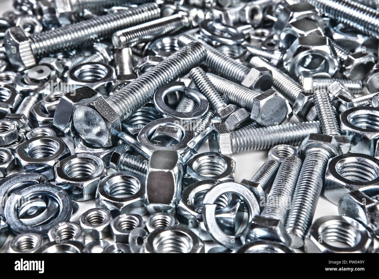 chromeplated bolts and nuts on white background Stock Photo - Alamy