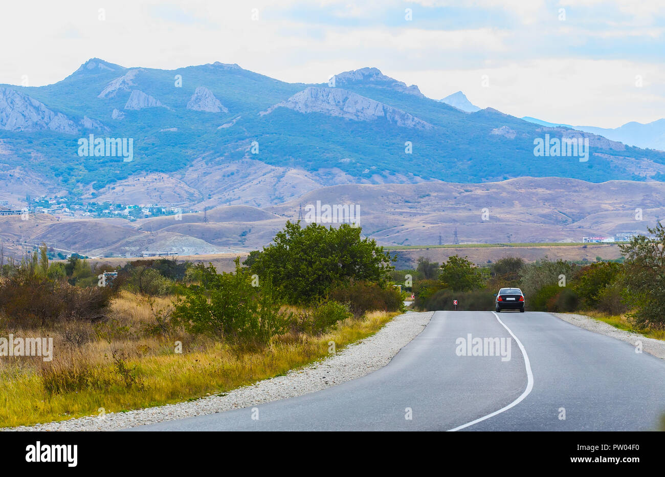 Beautiful scenery with mountains, road and car Stock Photo - Alamy