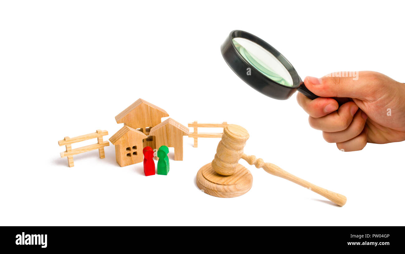 Magnifying glass is looking at the Wooden apartment house with people ...