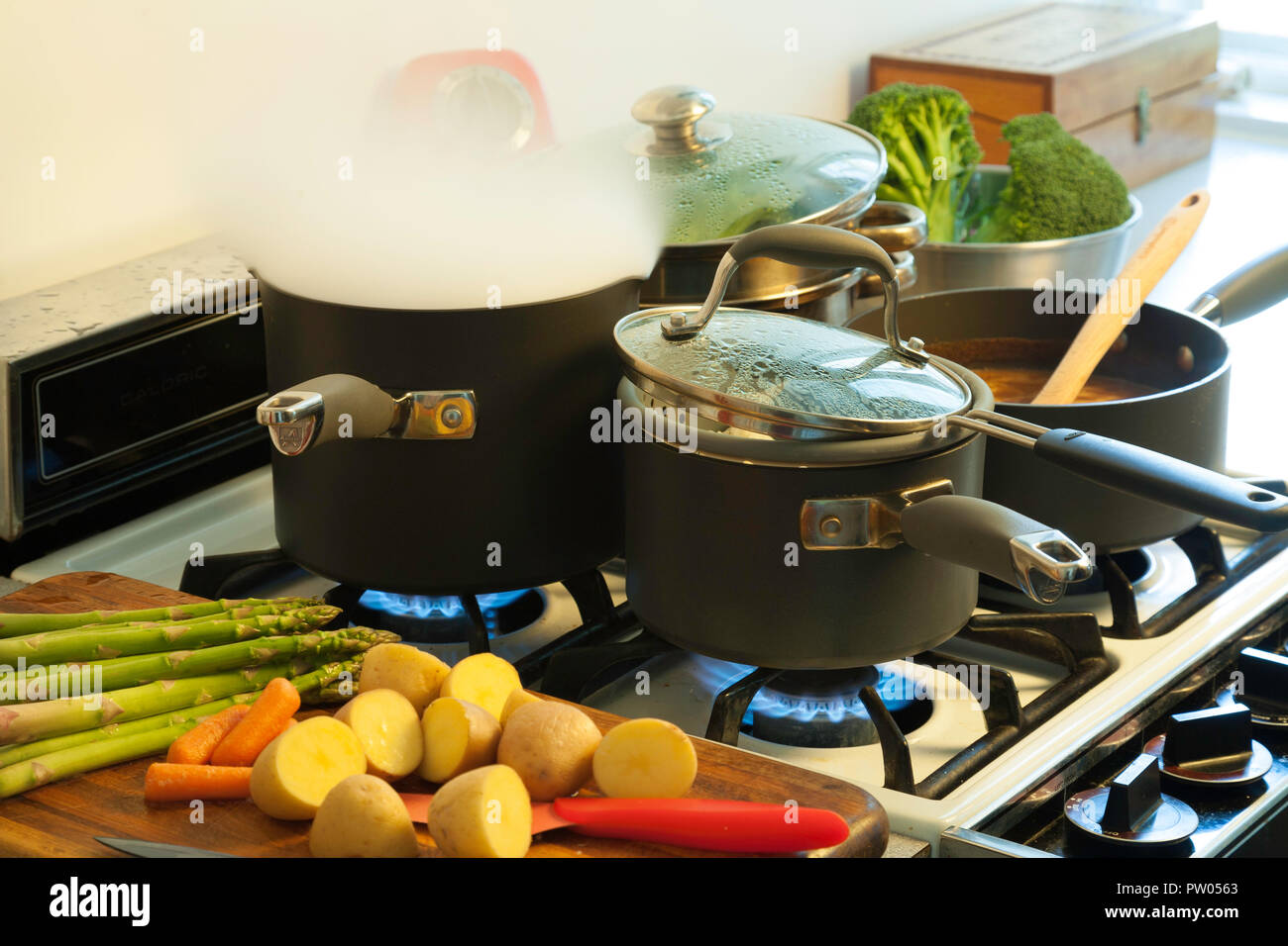 Steaming Pots on Residential Stovetop Stock Photo - Alamy