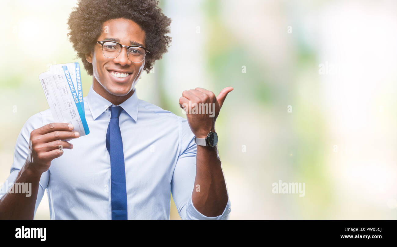 Afro american man holding boarding pass over isolated background ...