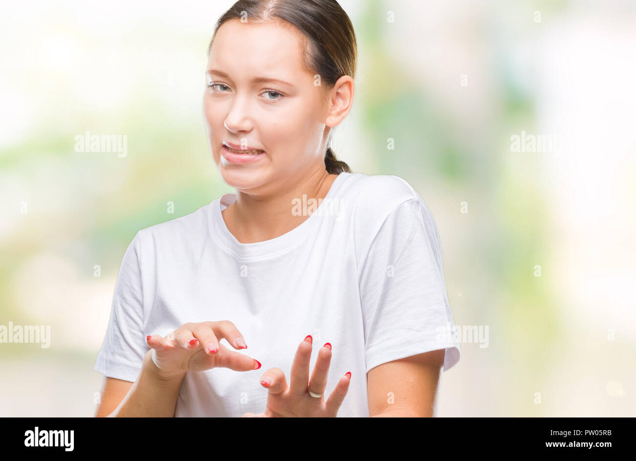 Young beautiful caucasian woman over isolated background disgusted ...