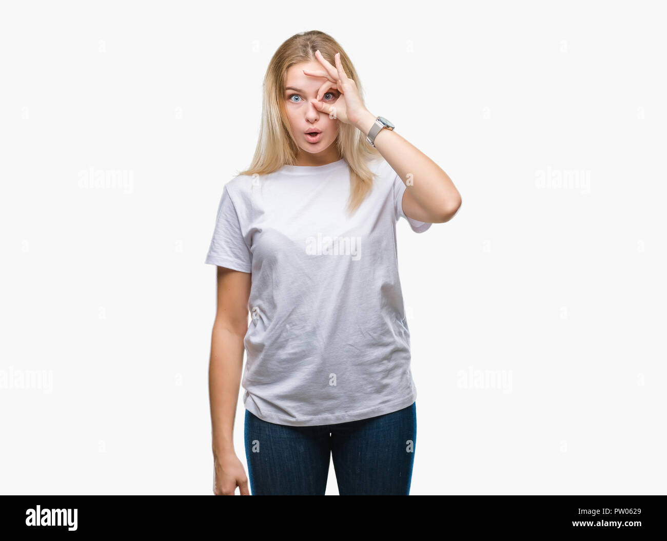 Young caucasian woman over isolated background doing ok gesture shocked ...