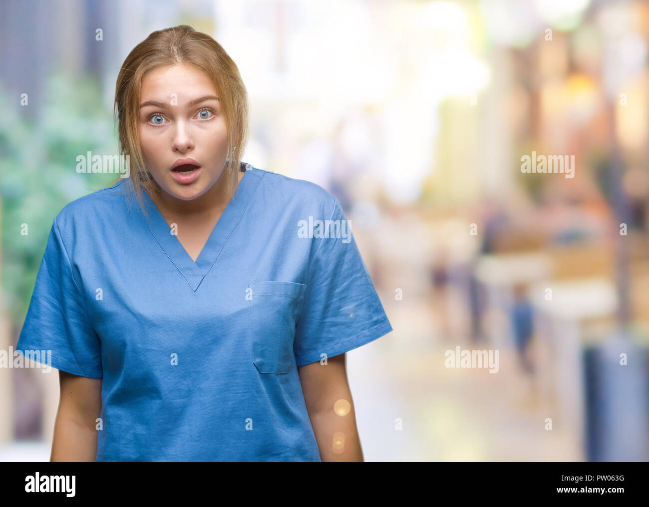 Young caucasian nurse woman wearing surgeon uniform over isolated ...