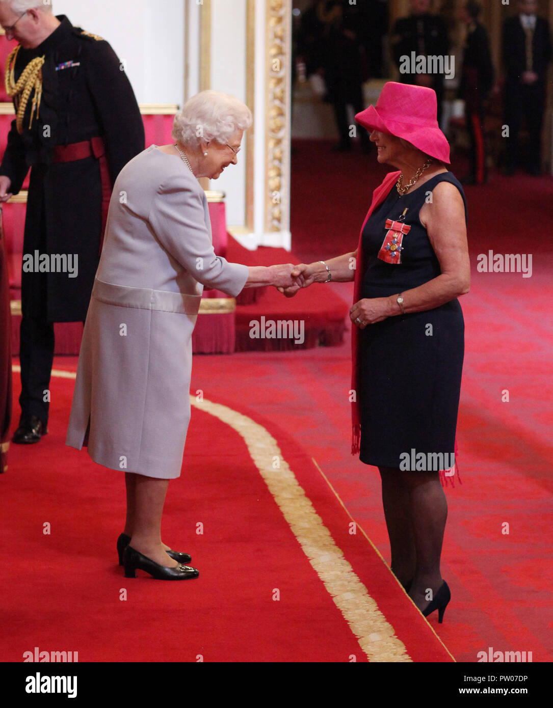 Is made a cbe by the queen at buckingham palace hi-res stock ...