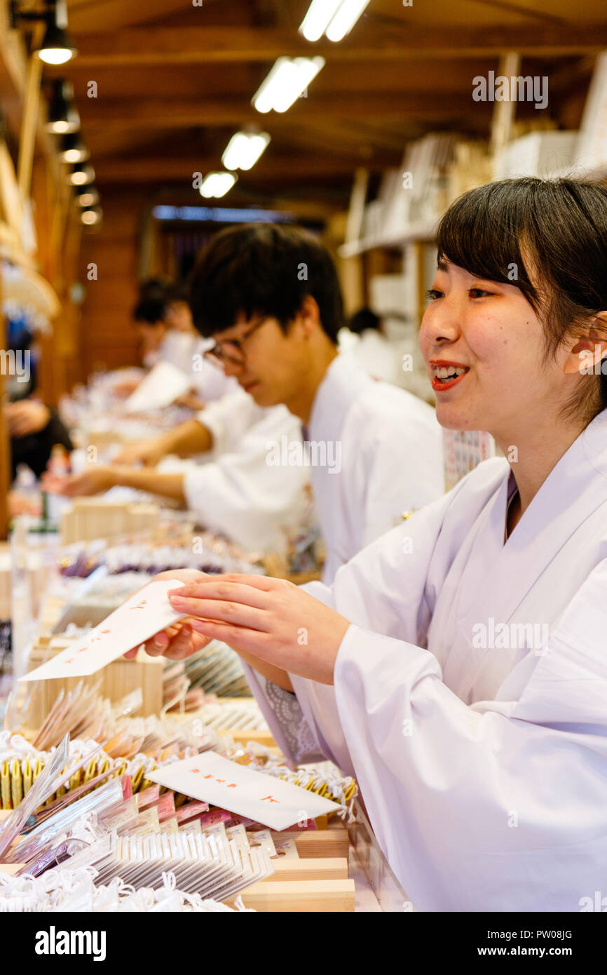 Japanese new year, shogatsu. Shrine Maidens, Miko, at office counter ...