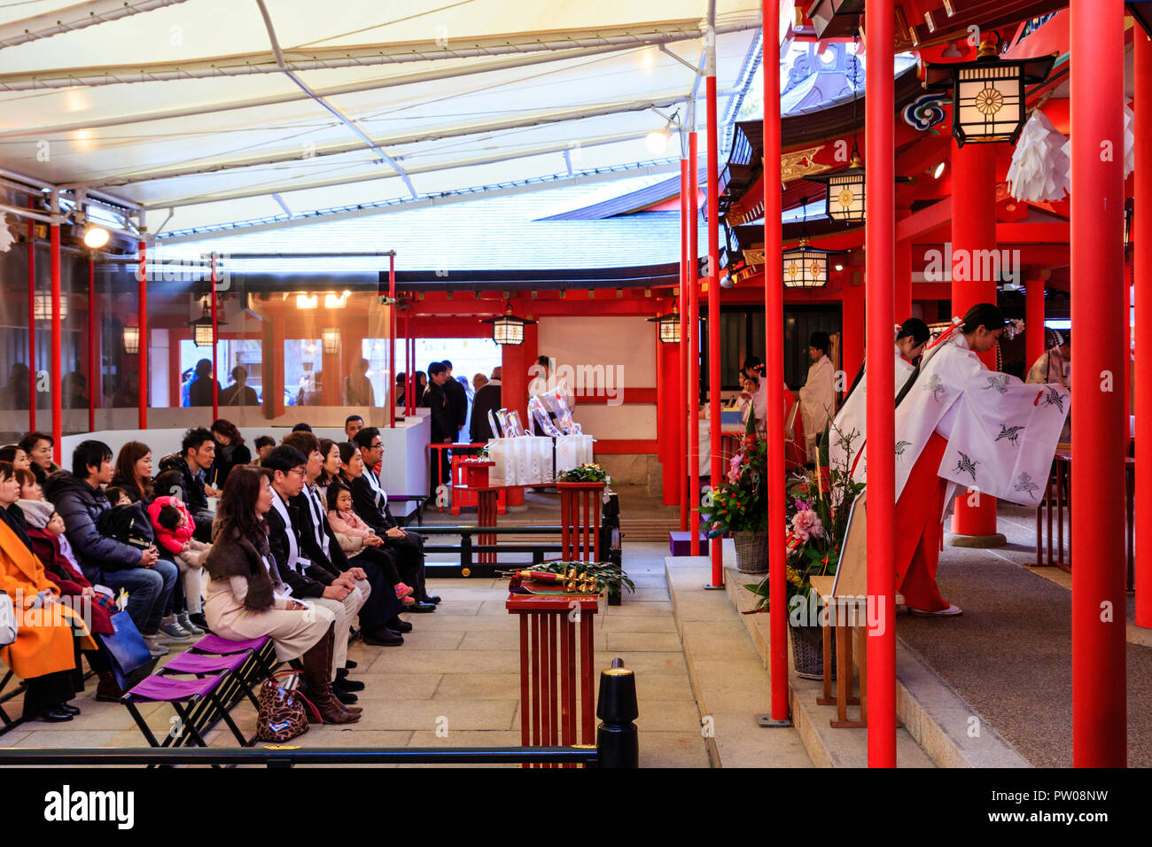 Japanese new year, shogatsu. Two shrine maidens, miko, performing a ...