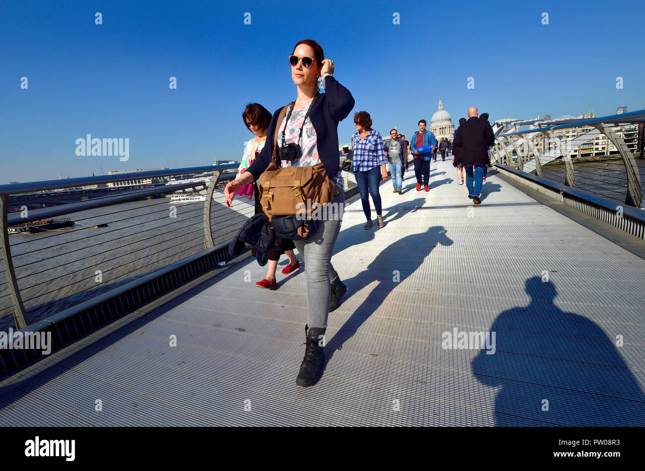 People crossing the Millennium Bridge, London, England, UK Stock Photo ...