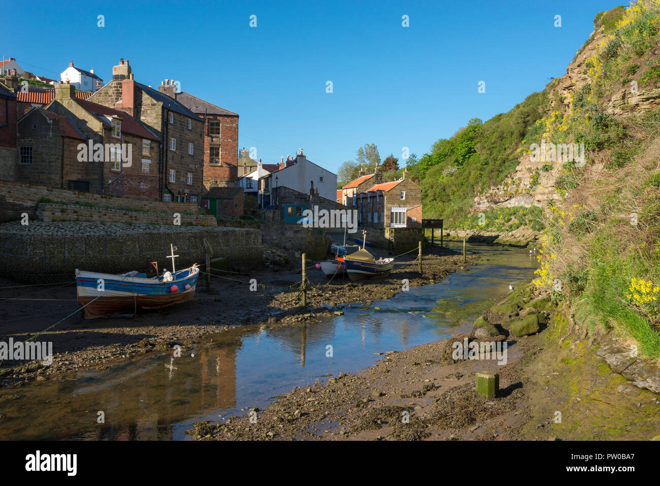 Boats moored in the beck at low tide, Staithes, North Yorkshire ...