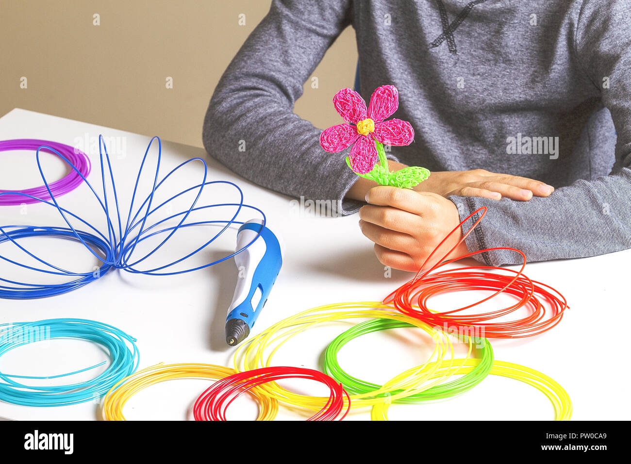 Kid's hands creating with 3d printing pen Stock Photo - Alamy