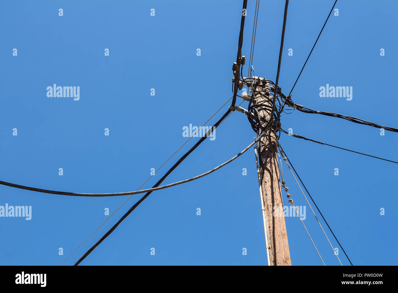 Traditional woden pole for electricity cables. Mountain village ...