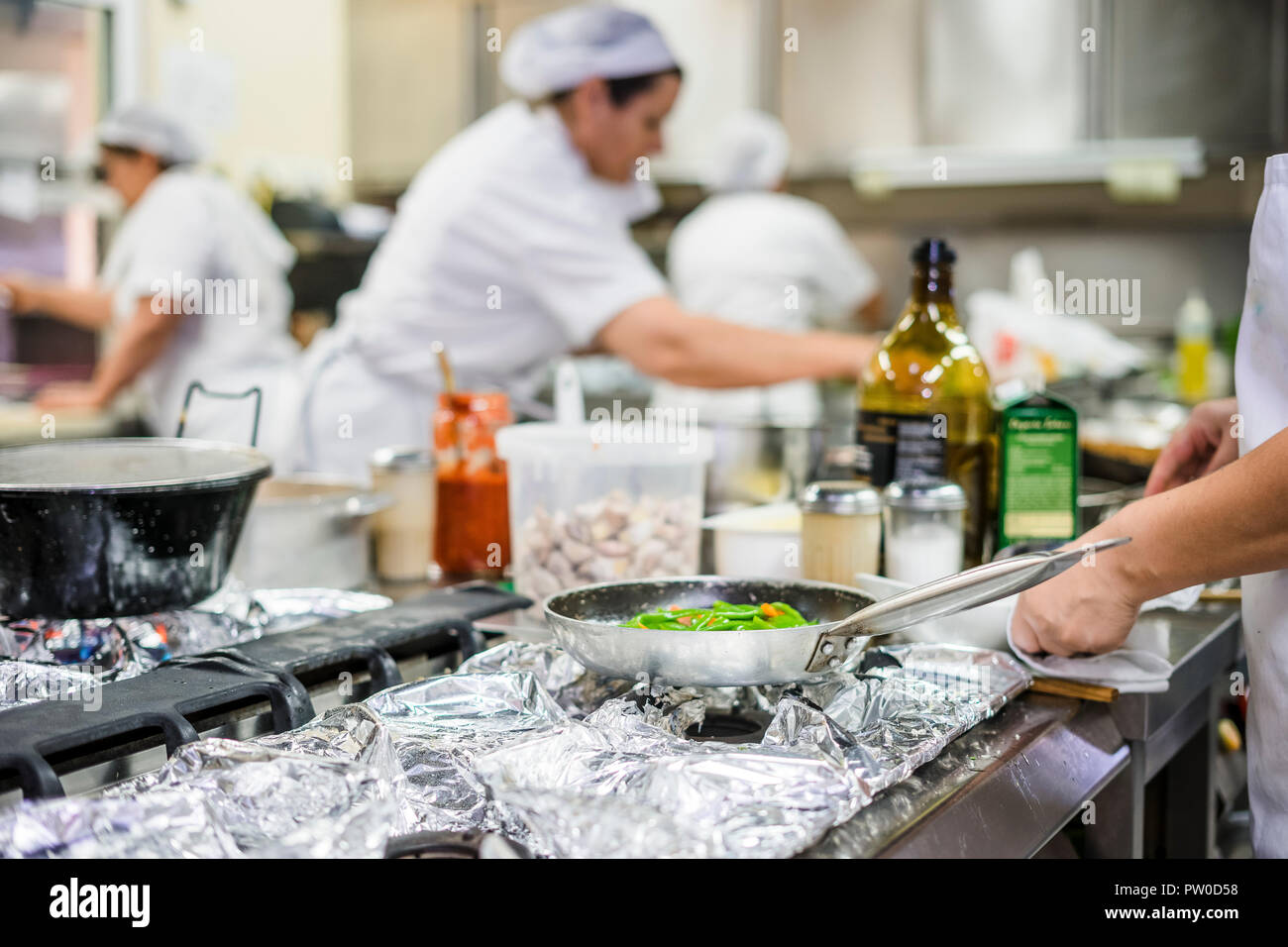 Kitchen staff busy with preparing vegetables during lunch time Stock ...