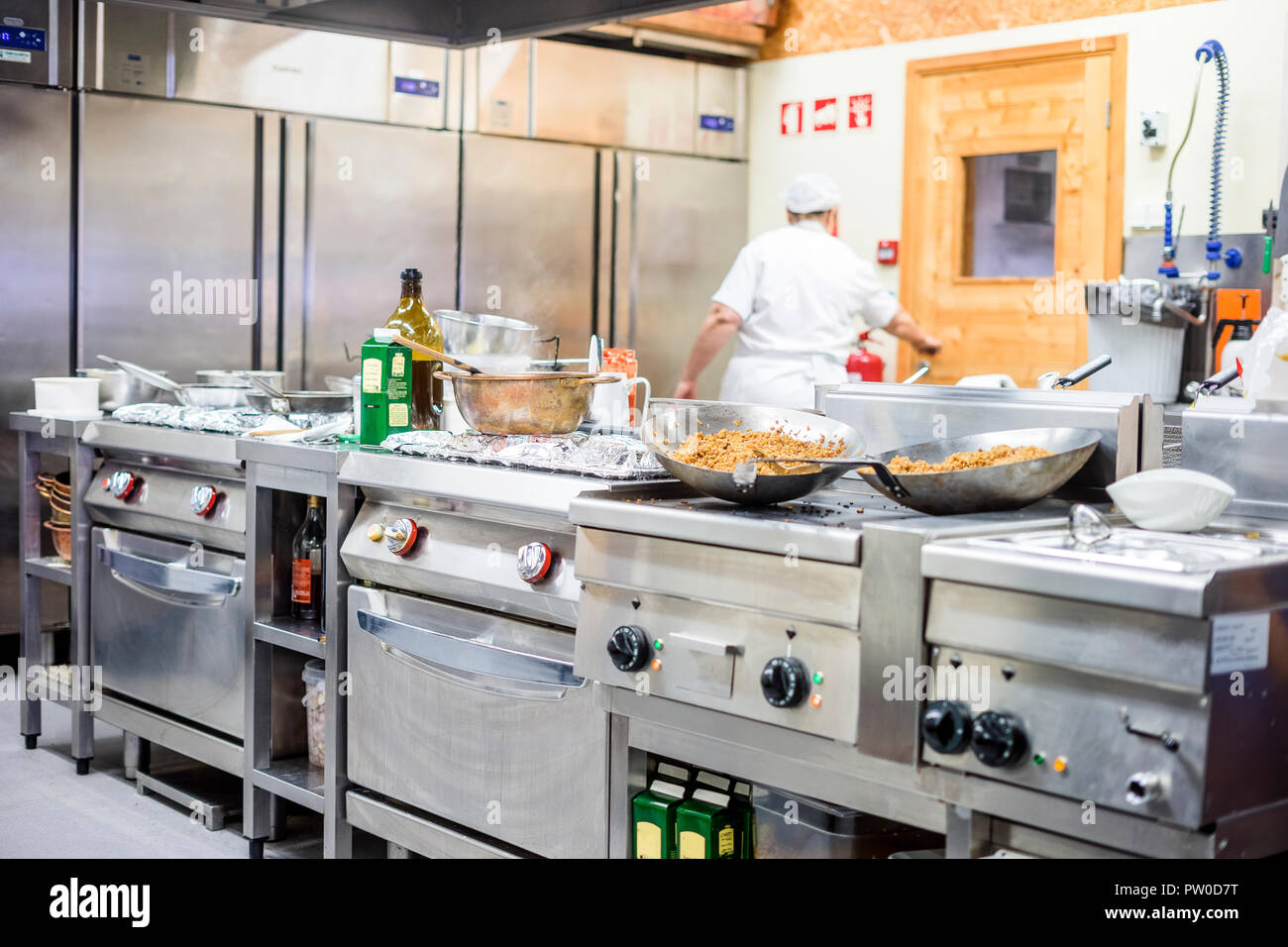 Kitchen staff busy with preparing food during lunch time in the ...