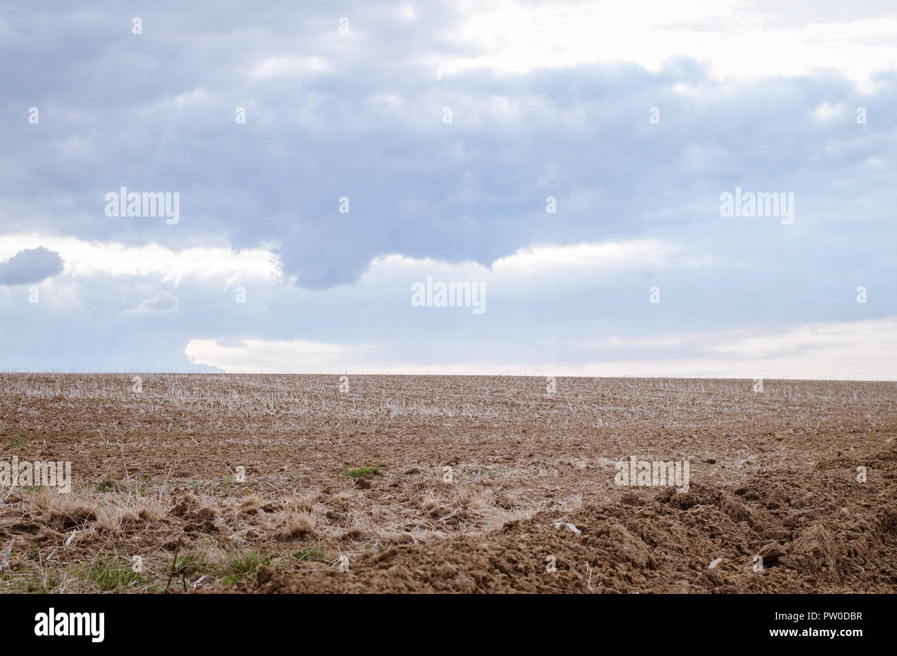 ploughed field and scary dark blue sky landscape Stock Photo - Alamy