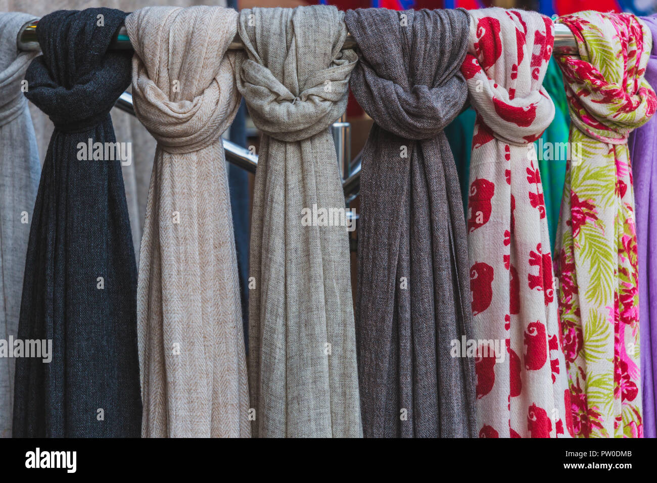 Colorful scarf hanging on a rod in a shop at market, Fashionable Cloth ...
