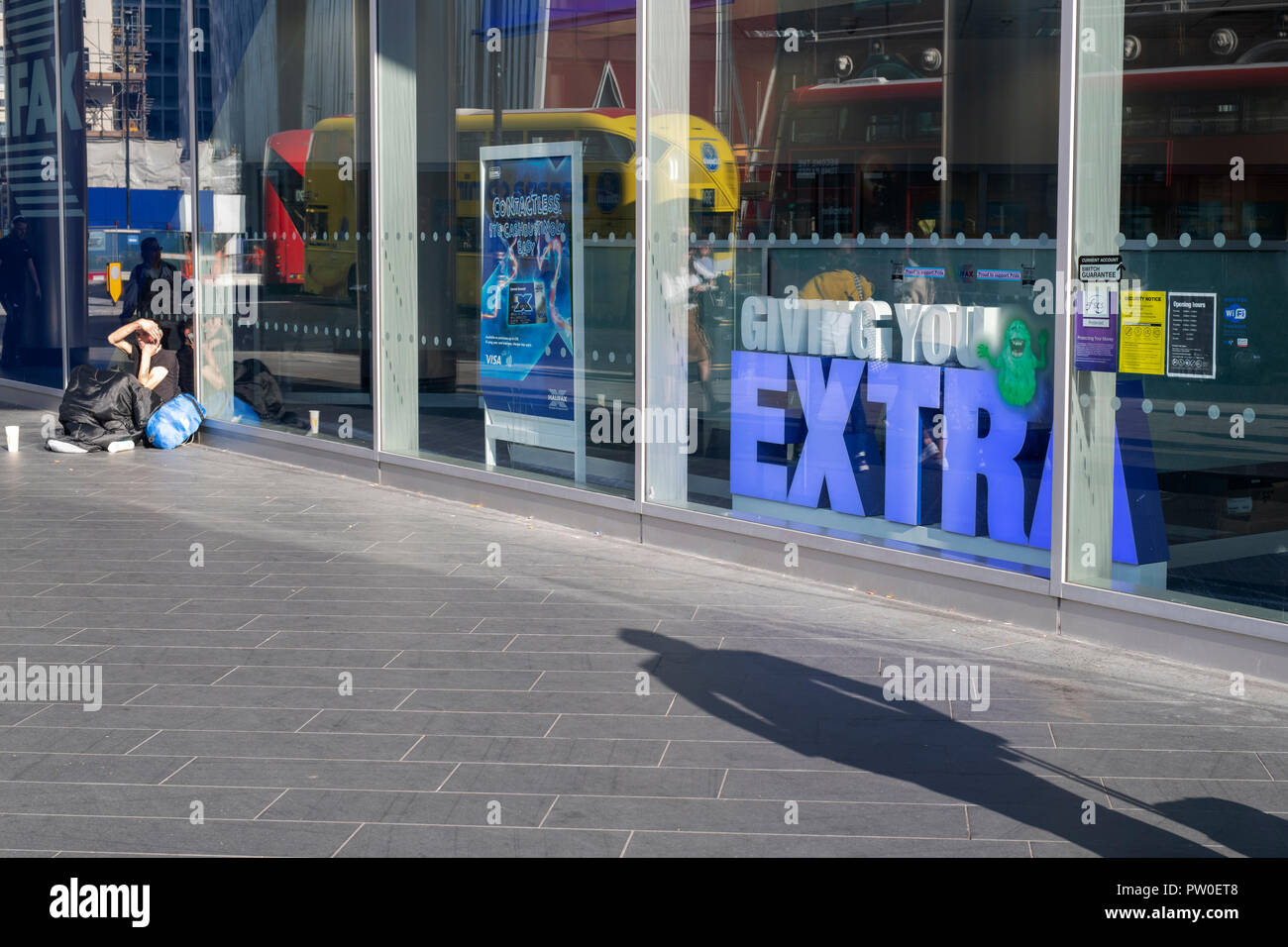 Homeless man sitting outside a halifax bank with a 'Giving you extra ...