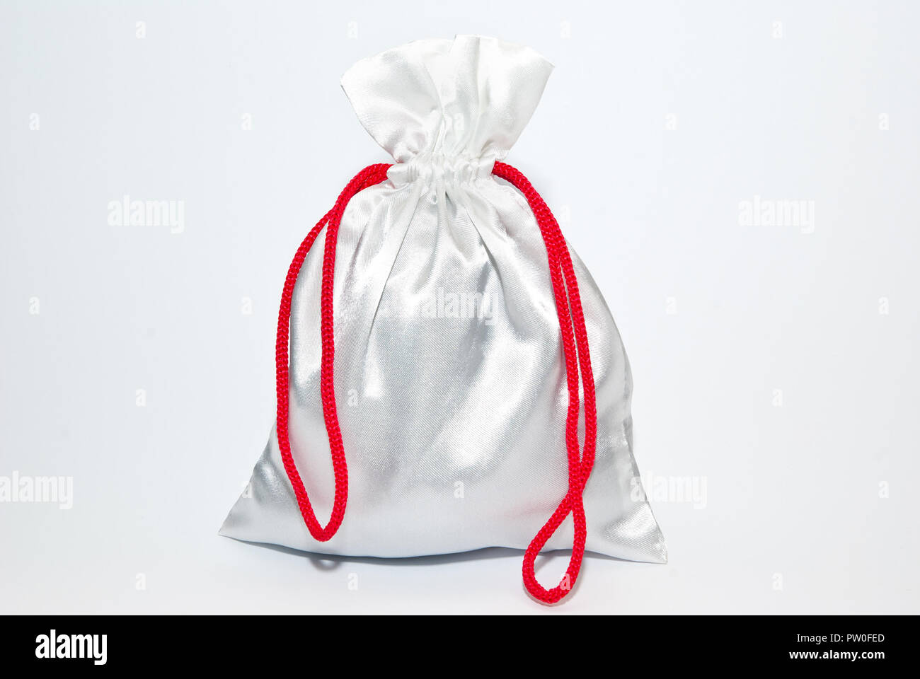 gift bag with red ribbon Stock Photo - Alamy