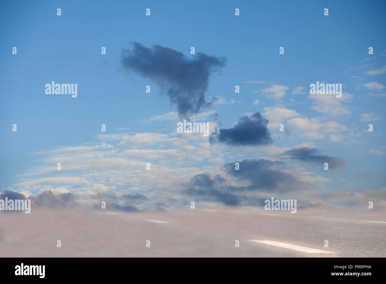 Straight road with white markings to heaven close up Stock Photo - Alamy