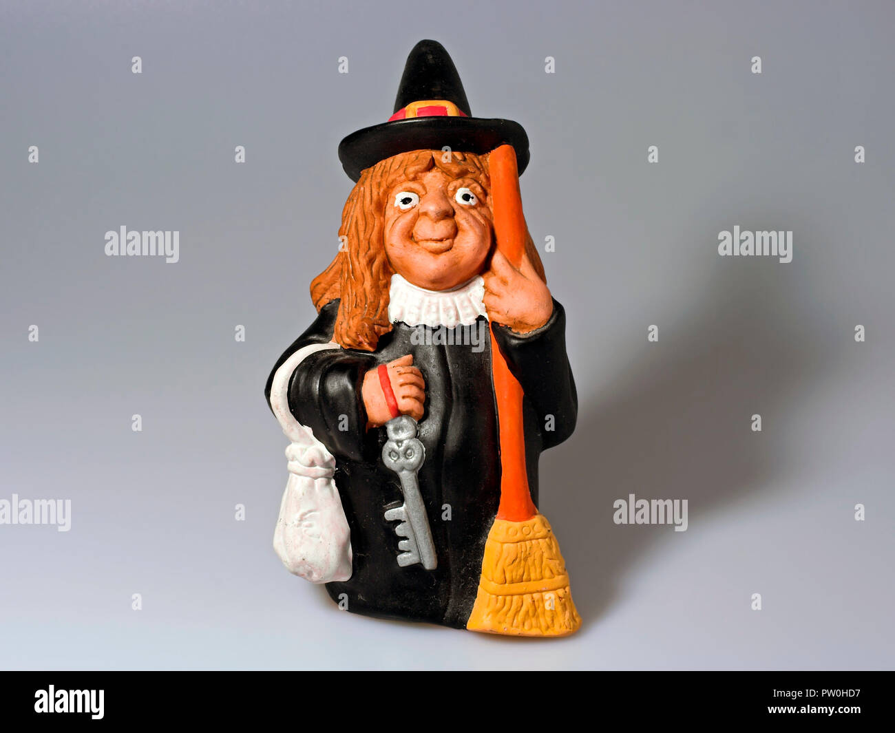 Colored and funny statuette of a witch (toy; popular art Stock Photo ...