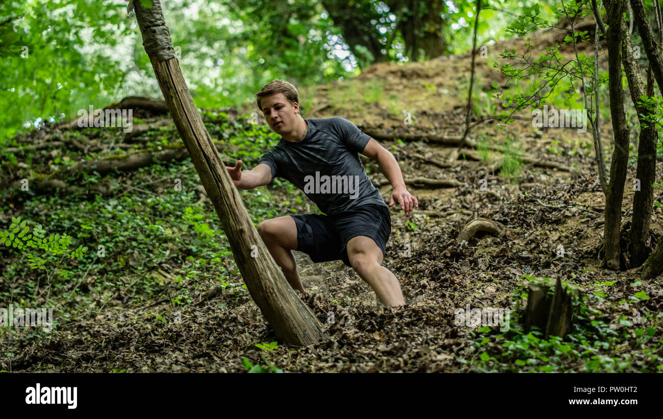 the guy is running down a steep hill while participating in an ocr race ...