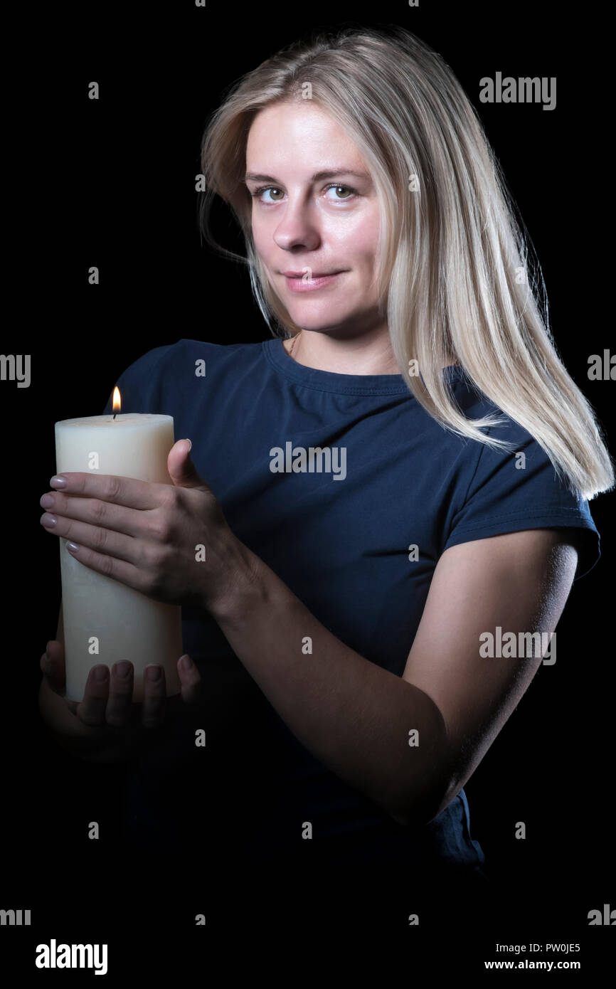 Woman candle darkness hi-res stock photography and images - Alamy