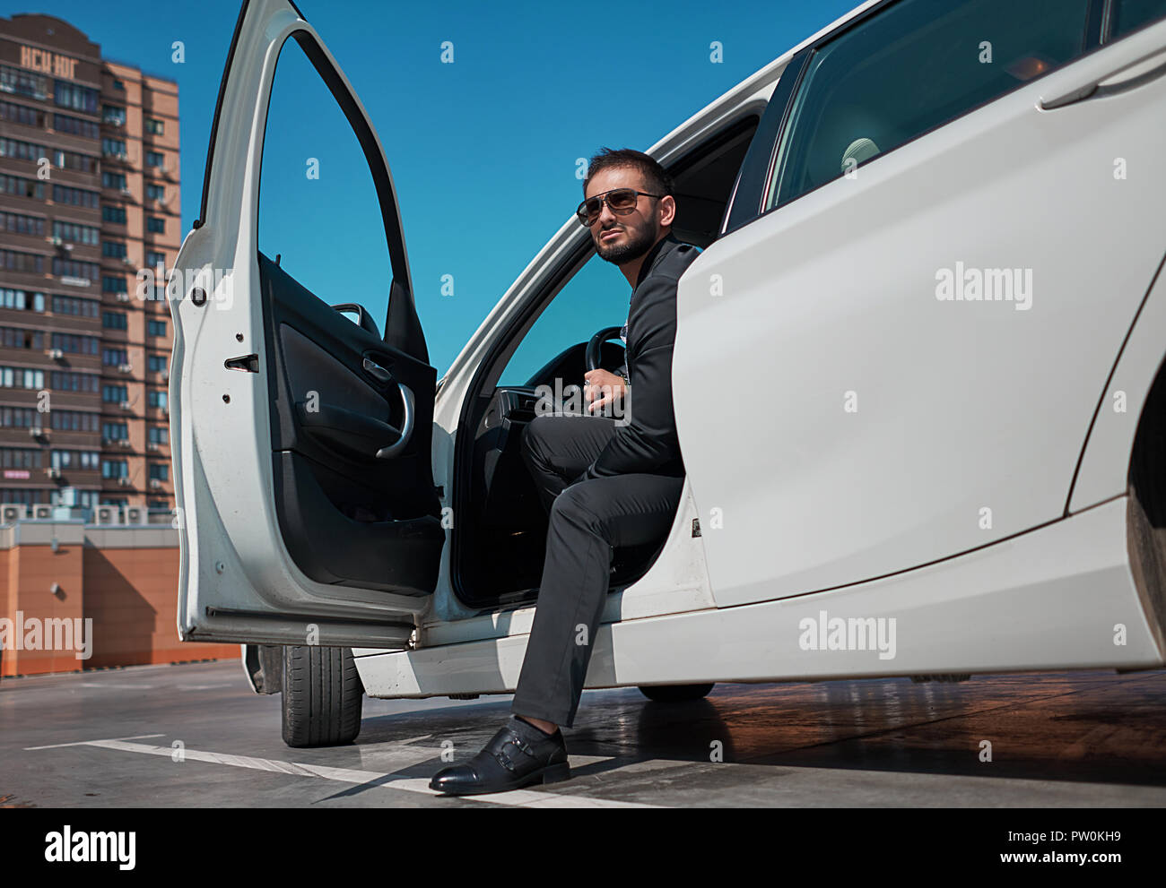 man in a jacket out of the car Stock Photo - Alamy