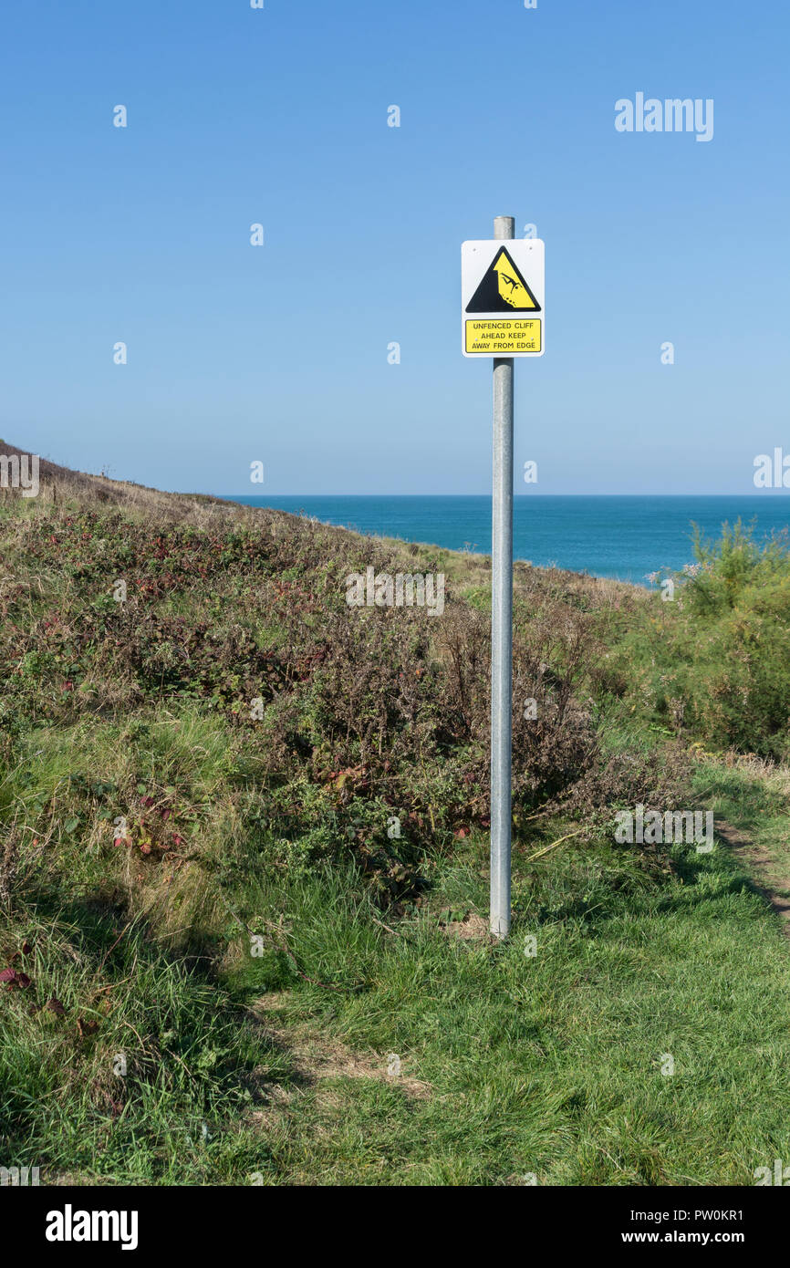 Cliff danger warning sign - with man falling over cliff, cliff edge ...