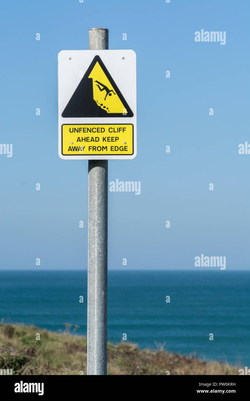 Cliff danger warning sign - with man falling over cliff, cliff edge ...