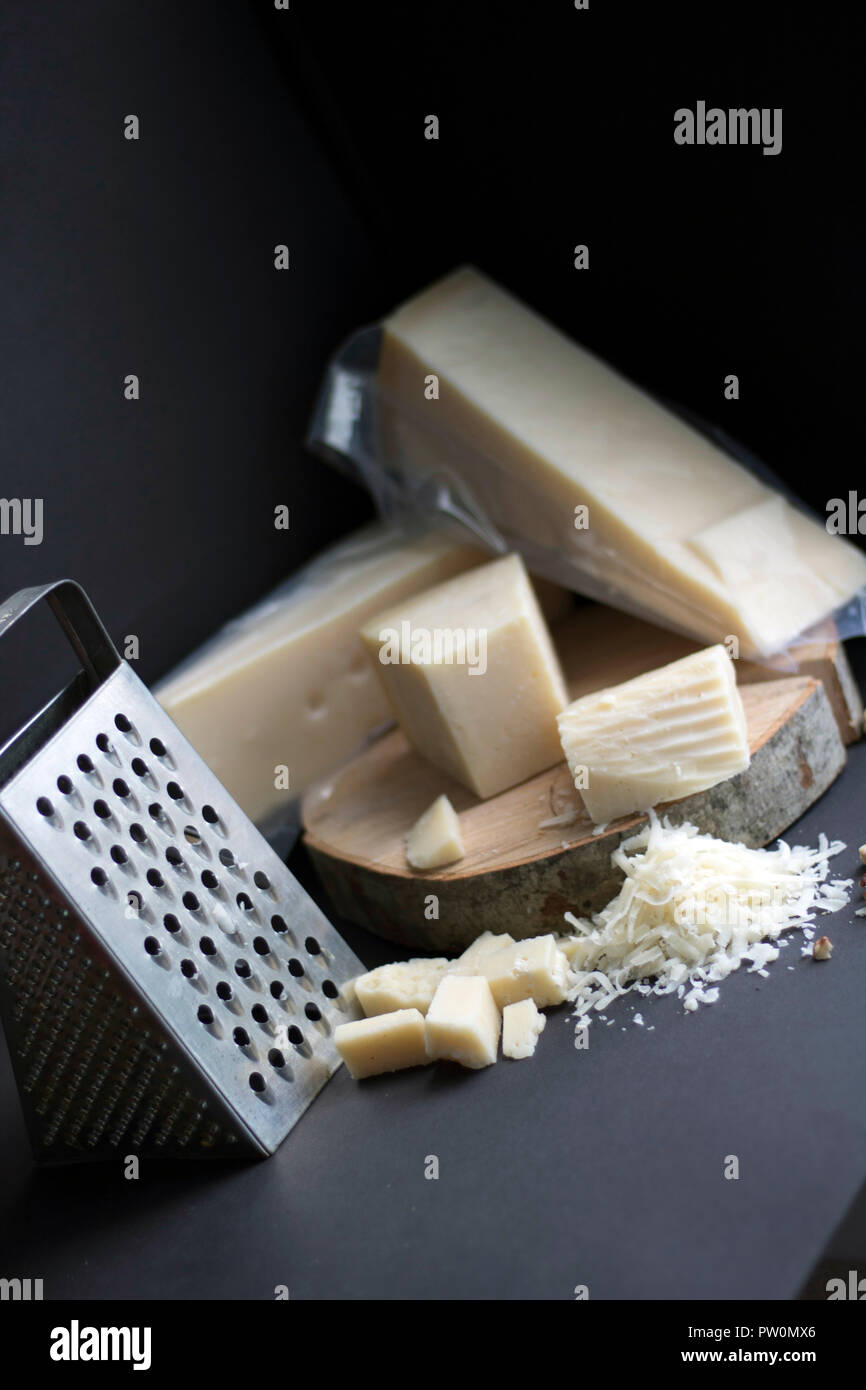 Dark background with grater and cheese on black background Stock Photo ...