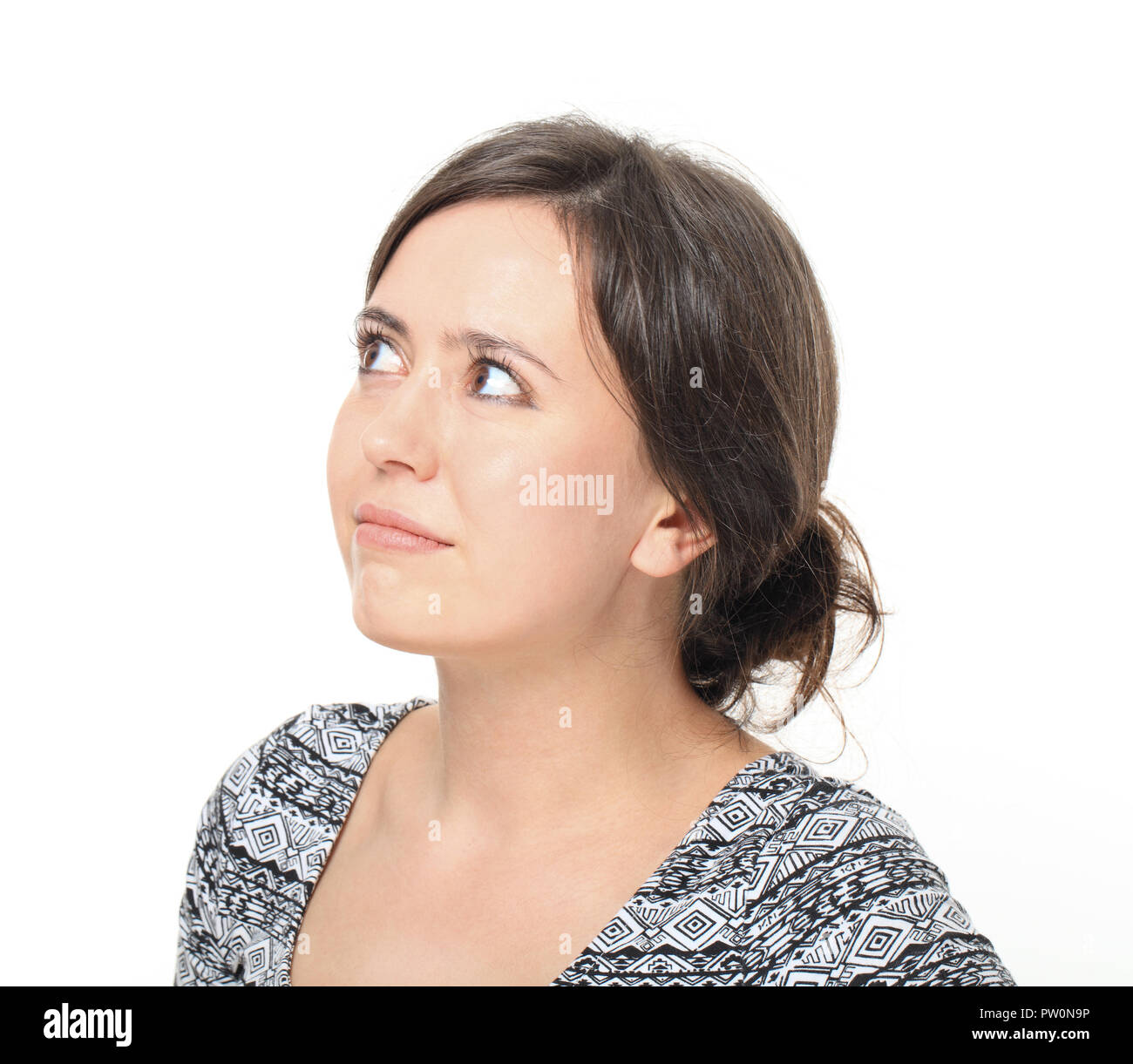 Young woman looking right with distrust Stock Photo - Alamy