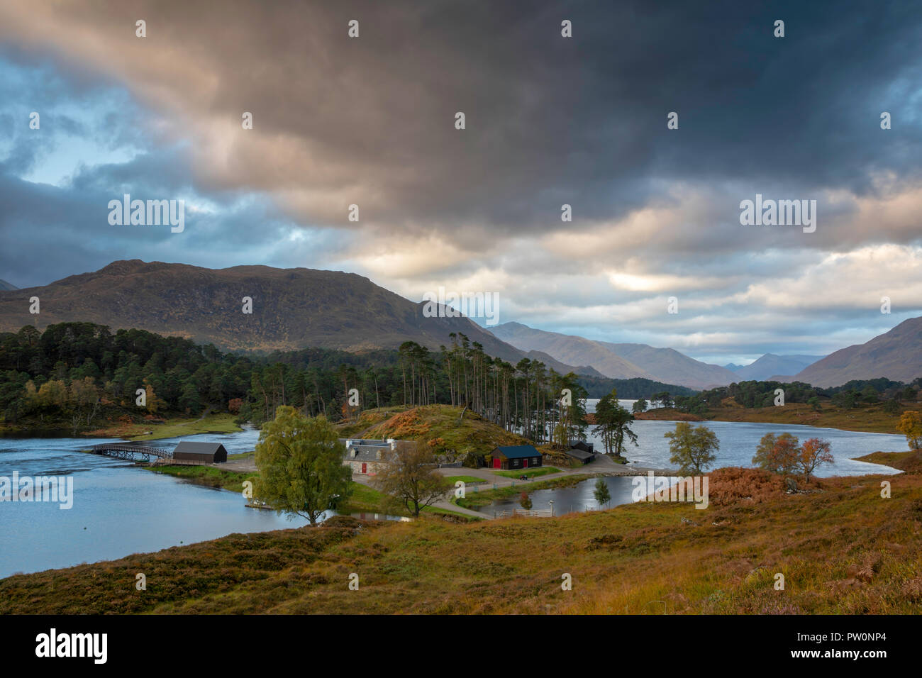 View of house at Affric estate surrounded by Loch with forest and ...