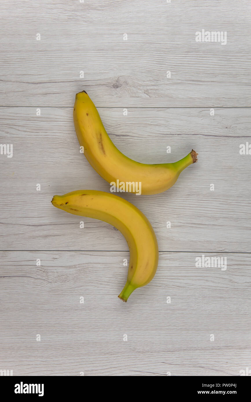 Bananas on white wood table, top view Stock Photo - Alamy