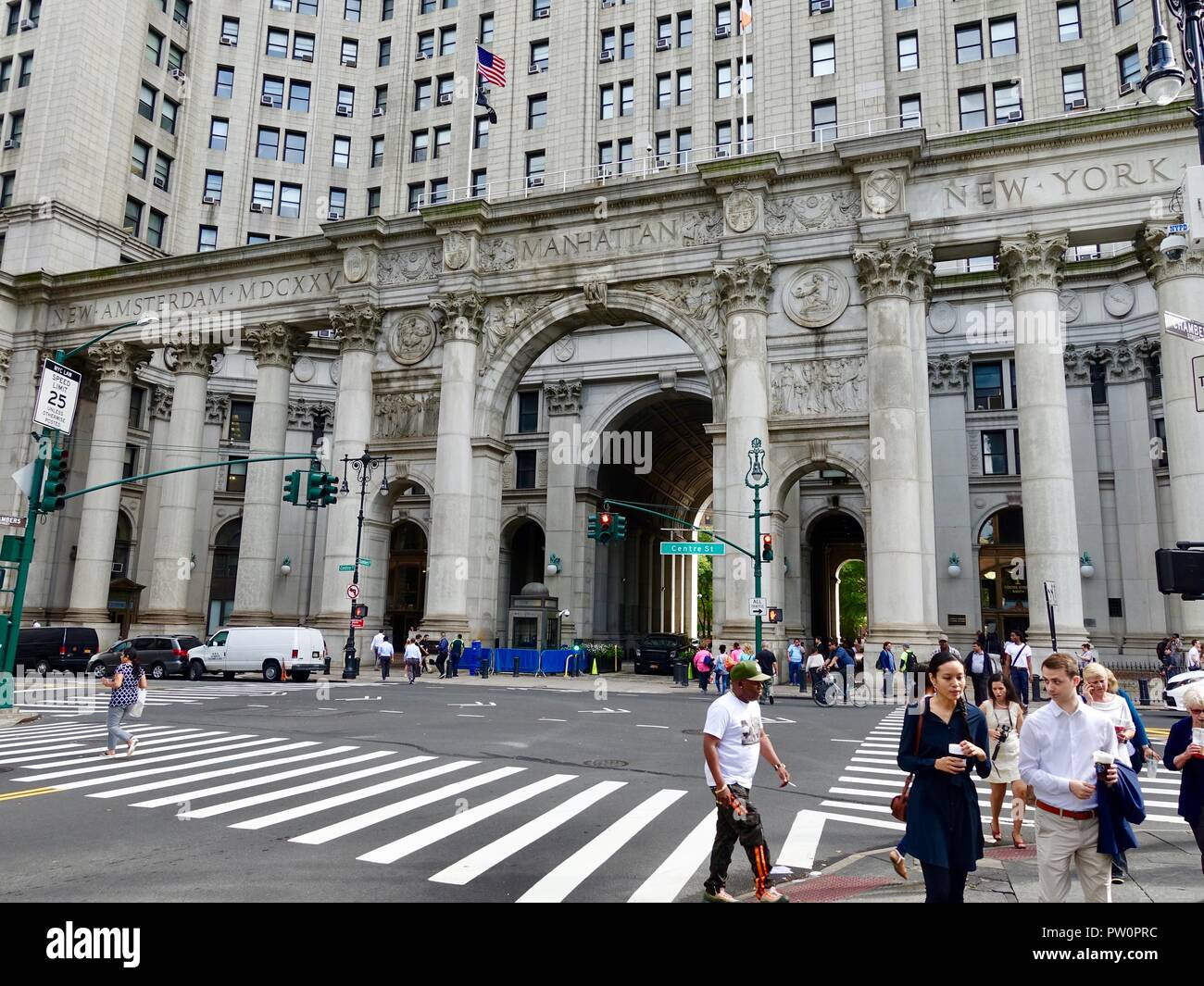 People walking past the Municipal Building and arch representing the ...
