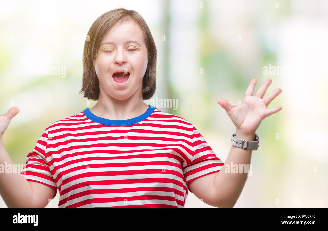 Young adult woman with down syndrome over isolated background crazy and ...