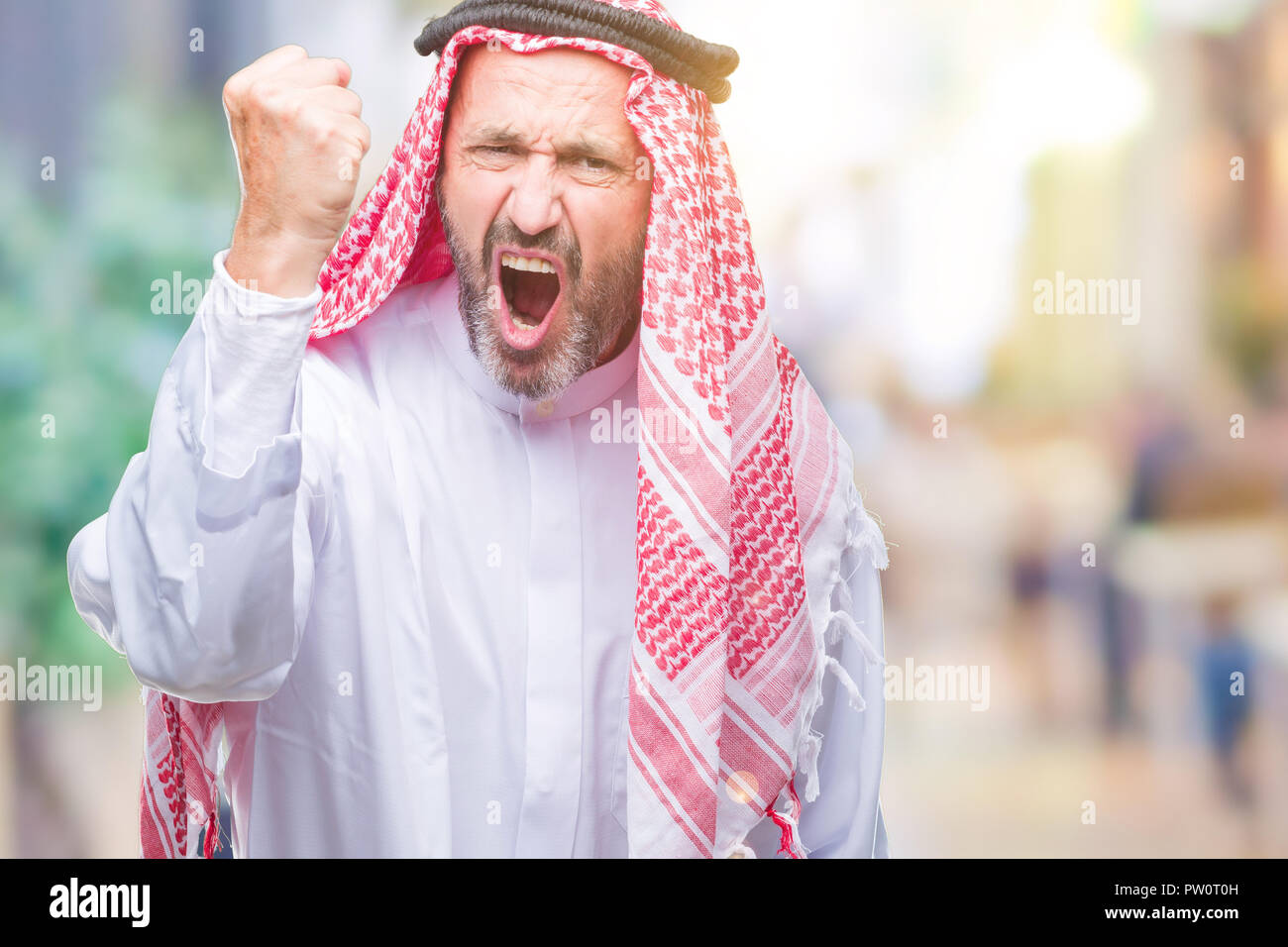 Senior arab man wearing keffiyeh over isolated background angry and mad ...