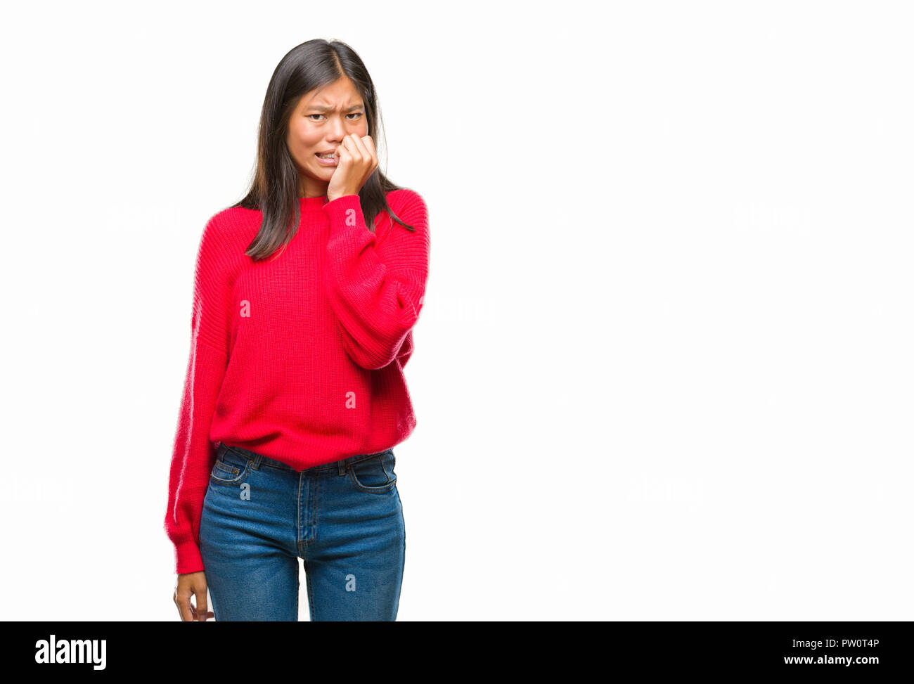 Young asian woman wearing winter sweater over isolated background ...